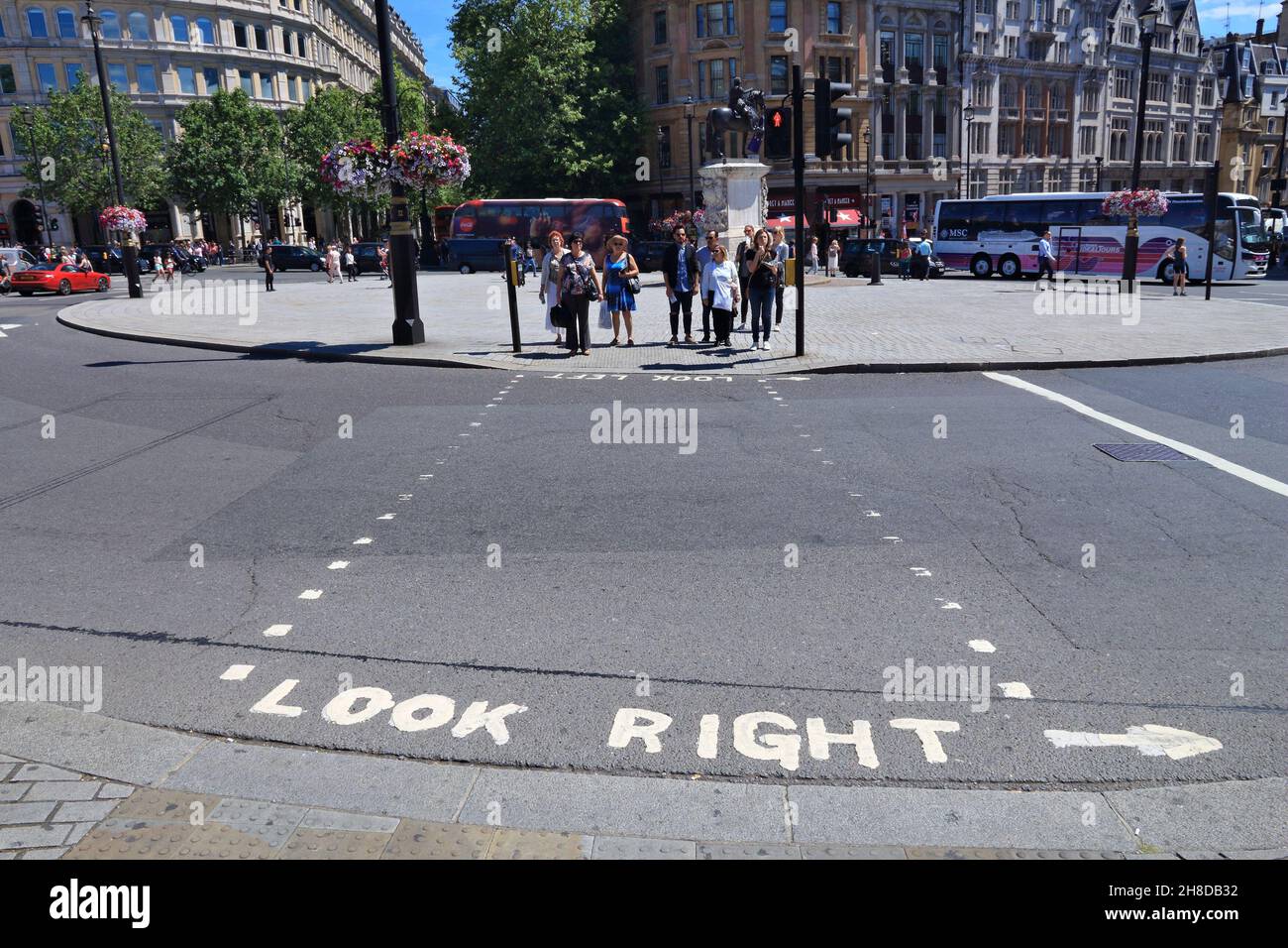 LONDON, UK - JULY 6, 2016: People cross a street at Trafalgar Square in ...