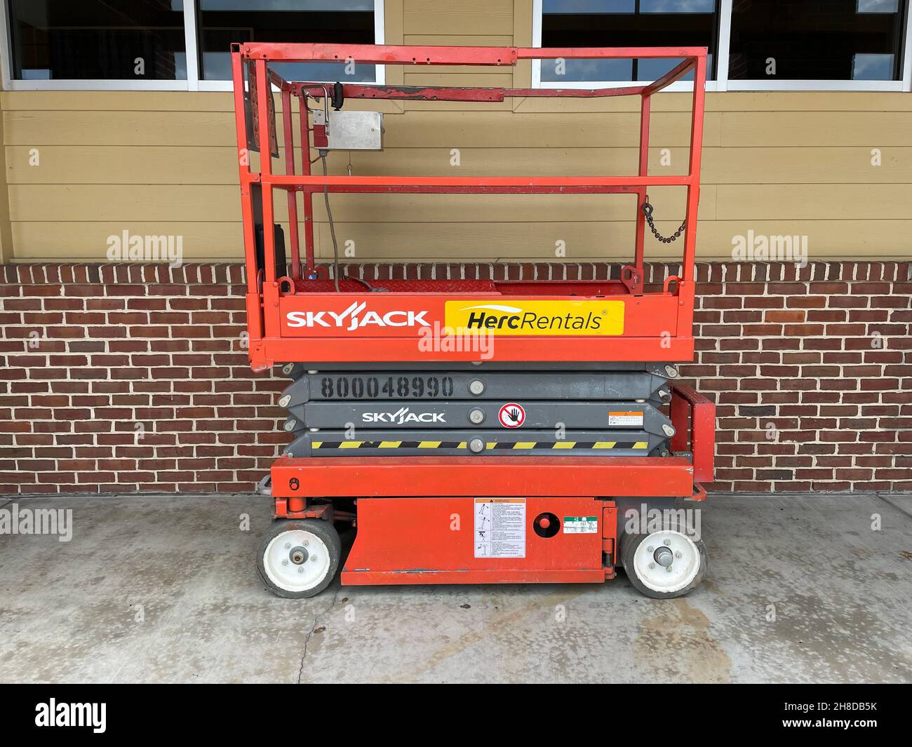 Augusta, Ga USA - 06 25 21: Orange hydraulic lift and brick wall Stock ...