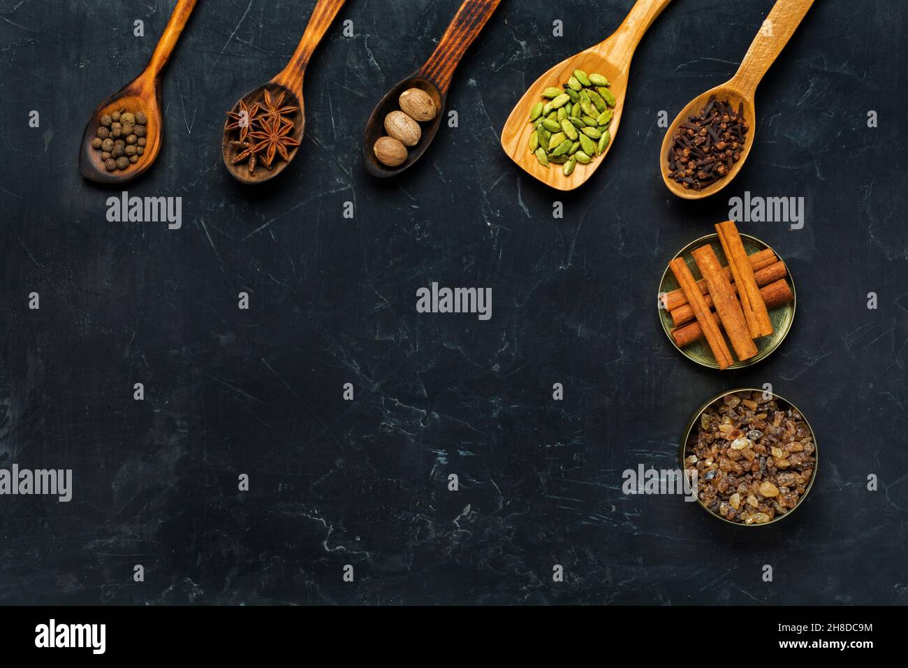 Spices selection over dark concrete background . Food or spicy cooking ...