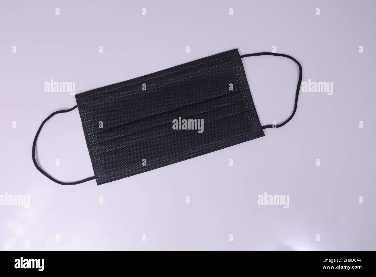 Closeup of a single black surgical mask on a white background Stock ...