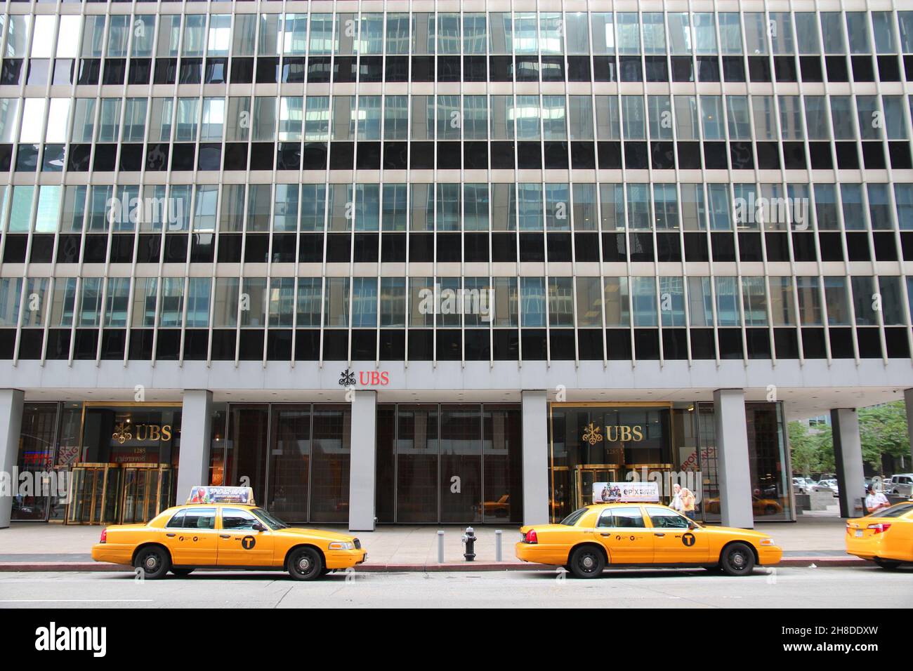 NEW YORK, USA - JULY 4, 2013: Yellow taxi cabs by UBS bank at Avenue of ...