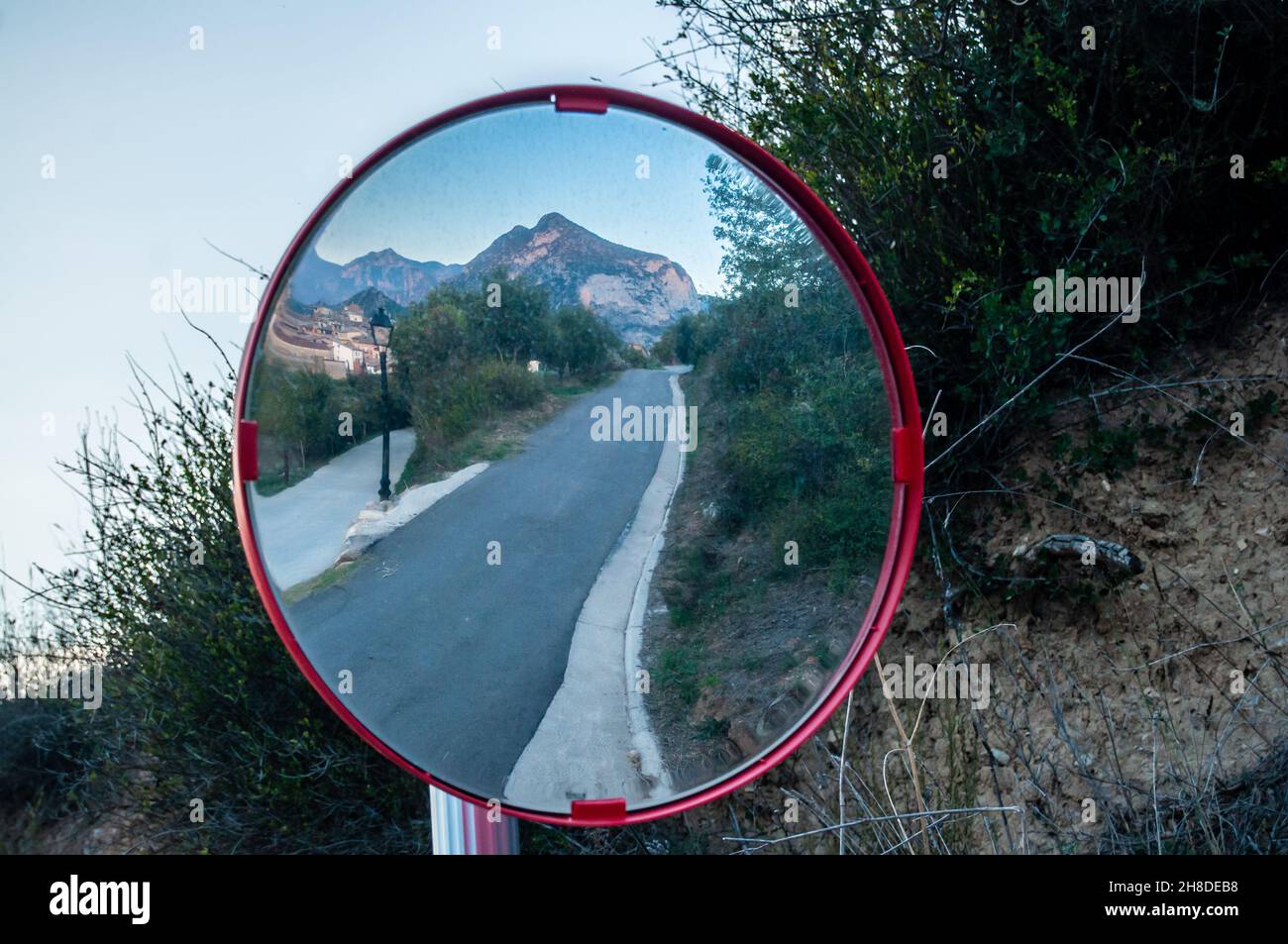 Traffic mirror with a road reflected on it Stock Photo - Alamy