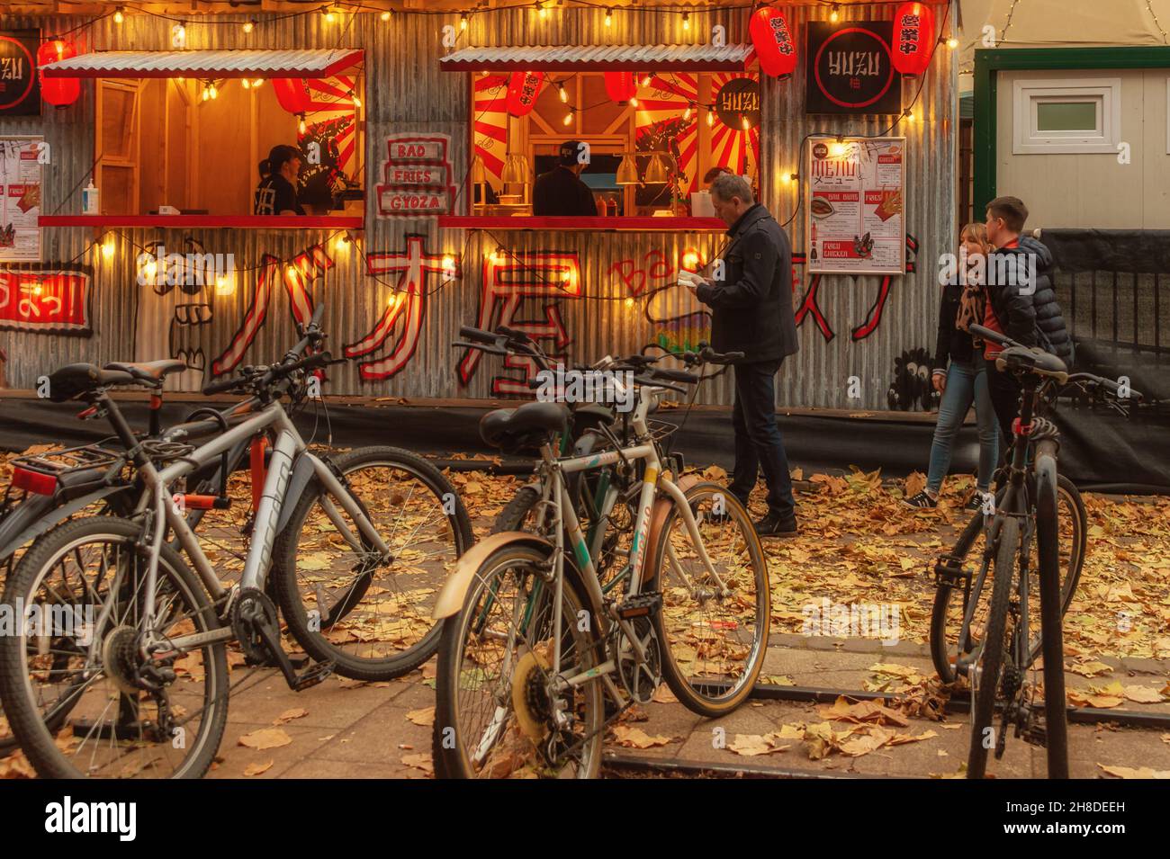 A fast food stall selling oriental street food. People queue to be ...
