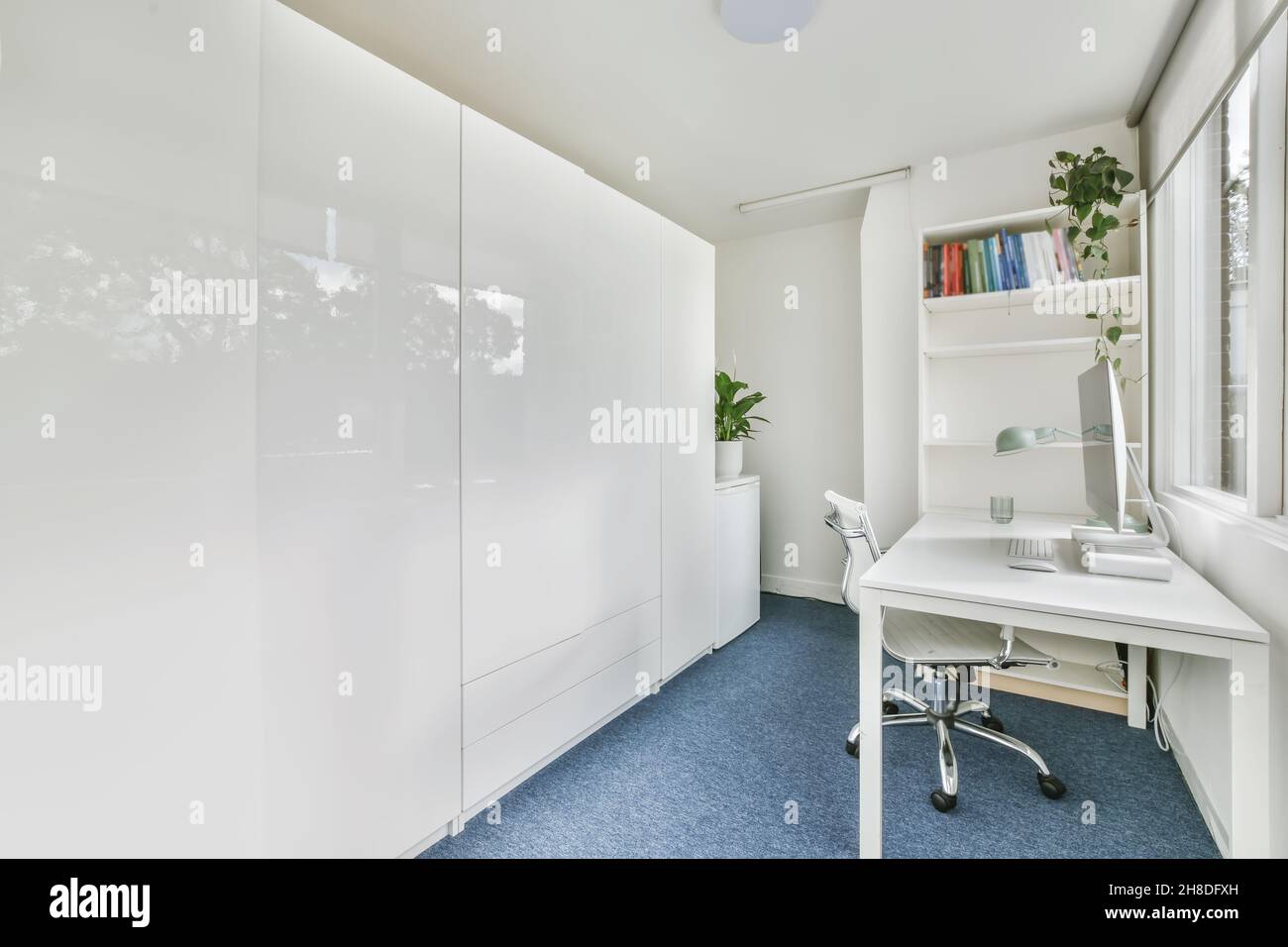 Bright work room with white long work table Stock Photo - Alamy