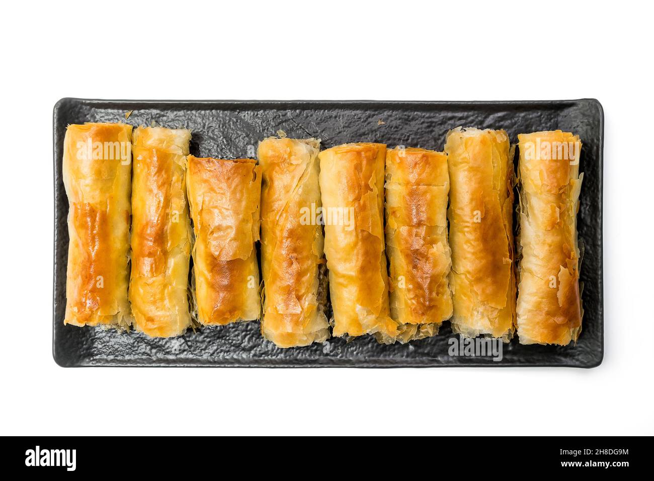 Meat rolls pastry - fried minced pork meat in spring rolls in a black ...