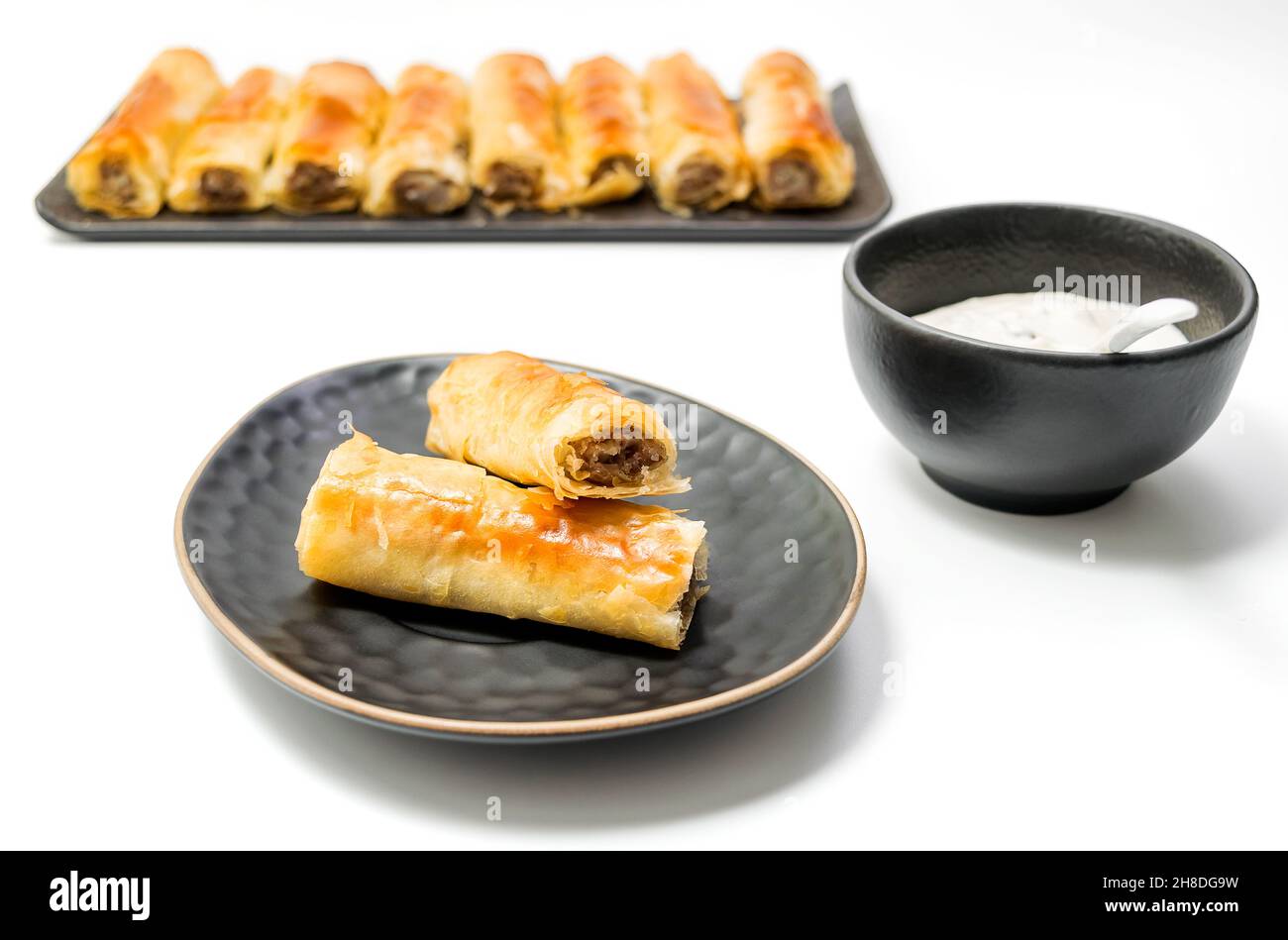 Meat rolls pastry - fried minced pork meat in spring rolls in a black ...
