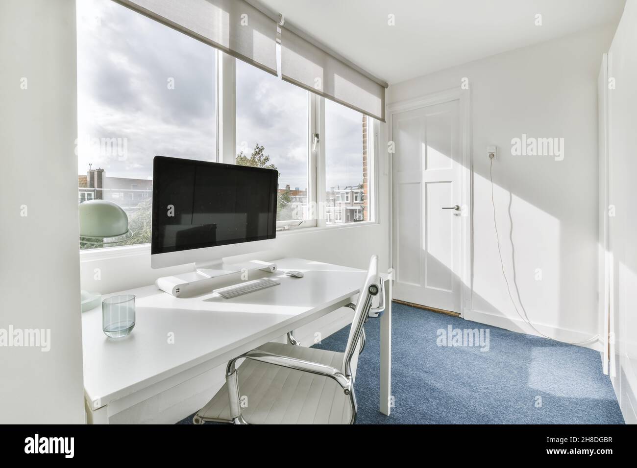 Bright work room with white long work table Stock Photo - Alamy