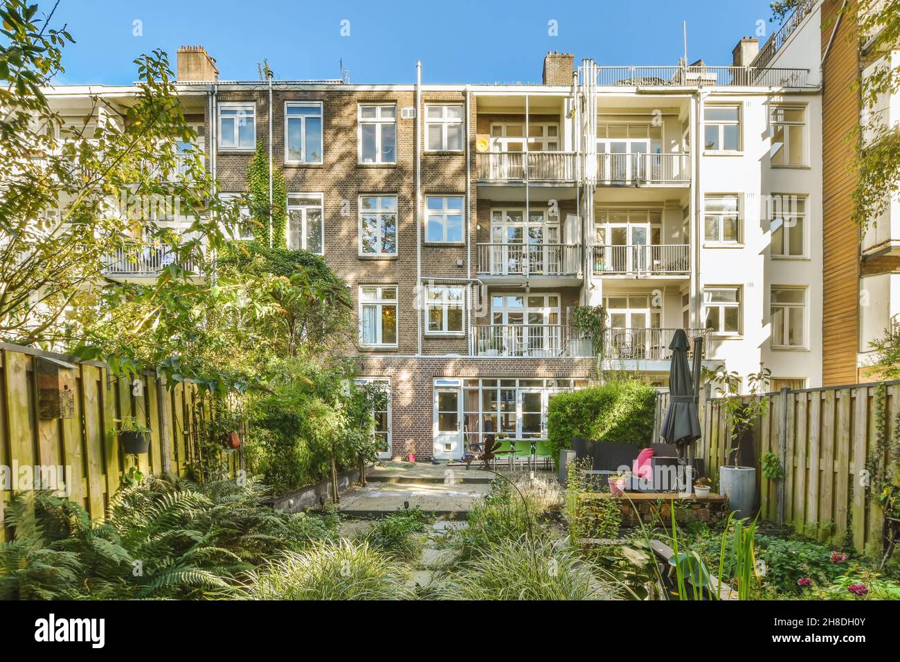 The courtyard of a multi-storey building overgrown with greenery Stock ...