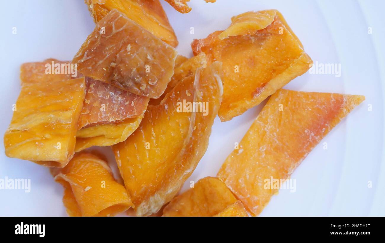 Close up of dried orange mango on plain white background Stock Photo ...
