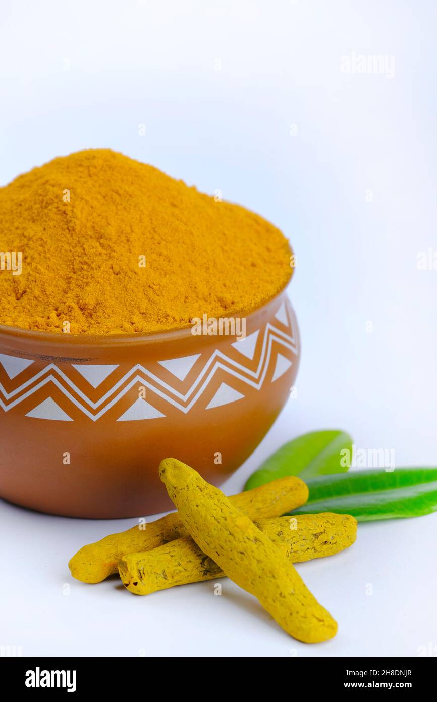 Turmeric Powder, Tumeric rhizome and turmeric powder in bowl isolated ...