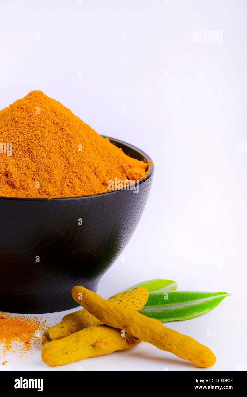 Turmeric Powder, Tumeric rhizome and turmeric powder in bowl isolated ...
