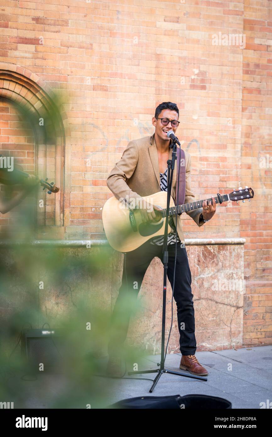 Busker singing and playing guitar on the street Stock Photo - Alamy