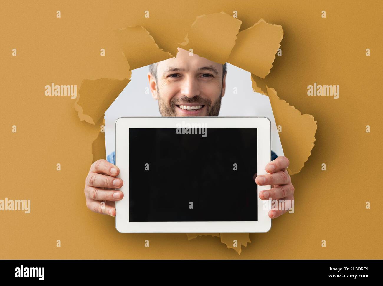 Man looking through ripped paper hole hi-res stock photography and ...