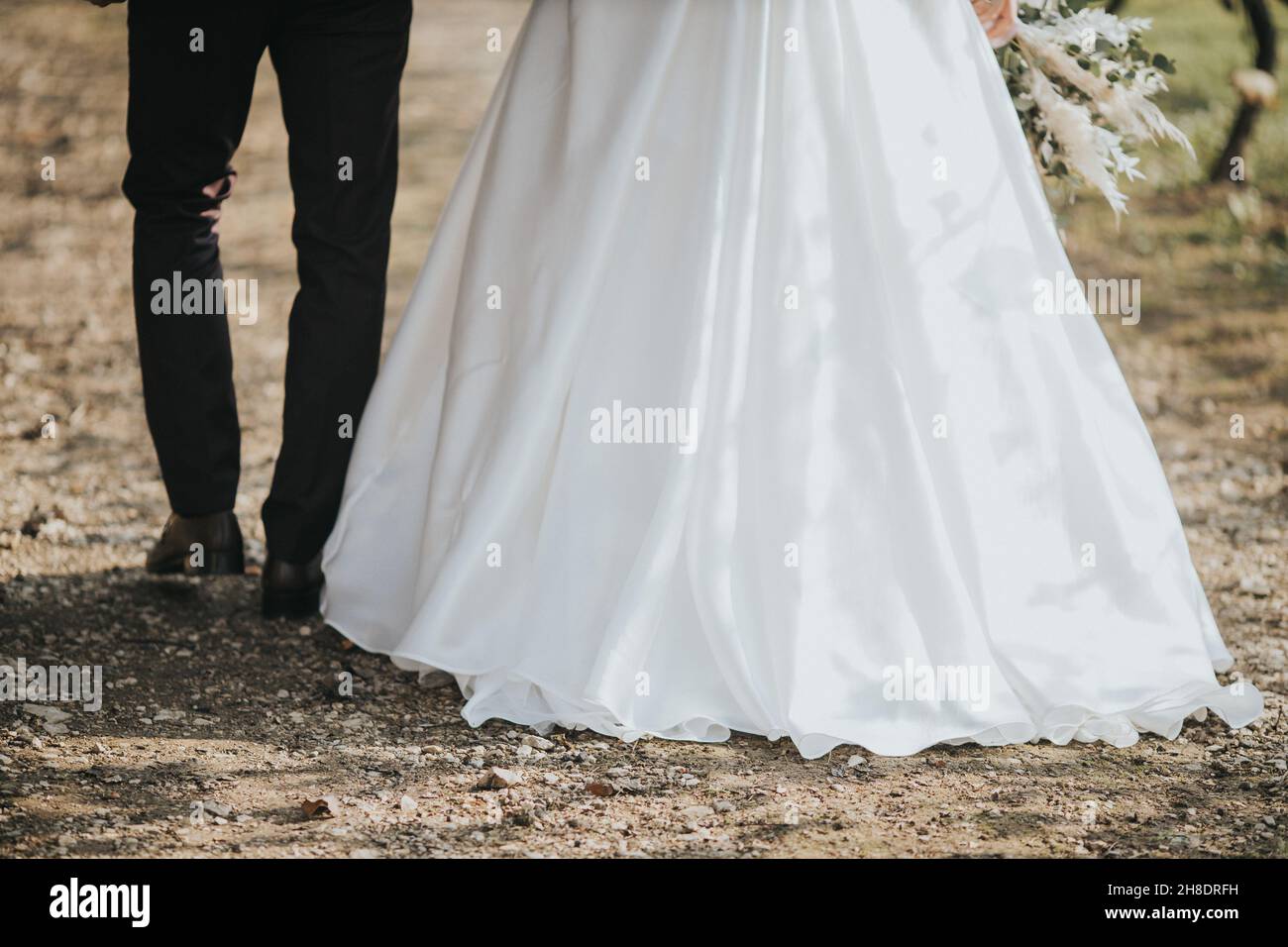 Closeup shot of bride and groom walking, visible only their legs Stock ...