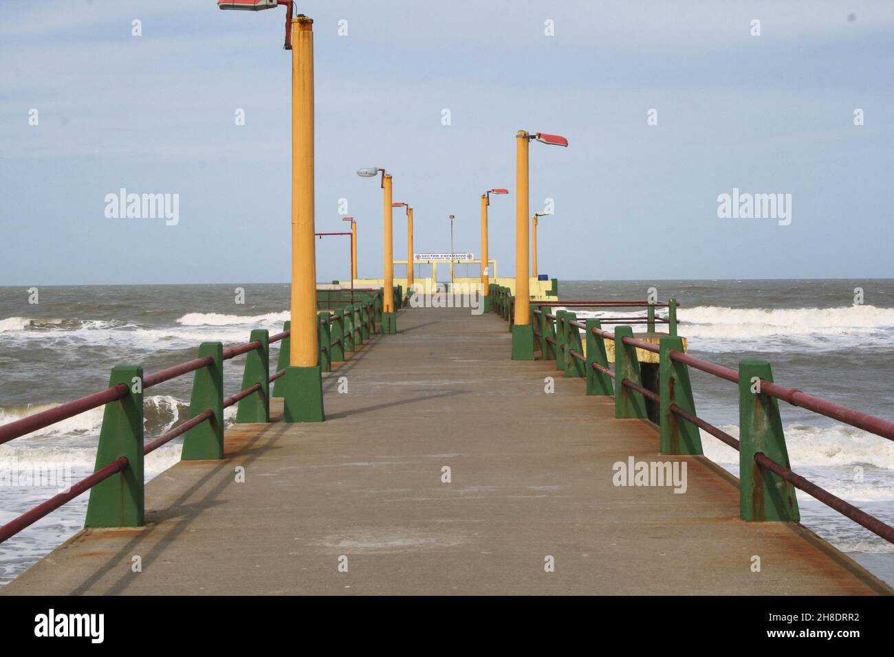 Long concrete piers with lights at the canal inlet Stock Photo - Alamy