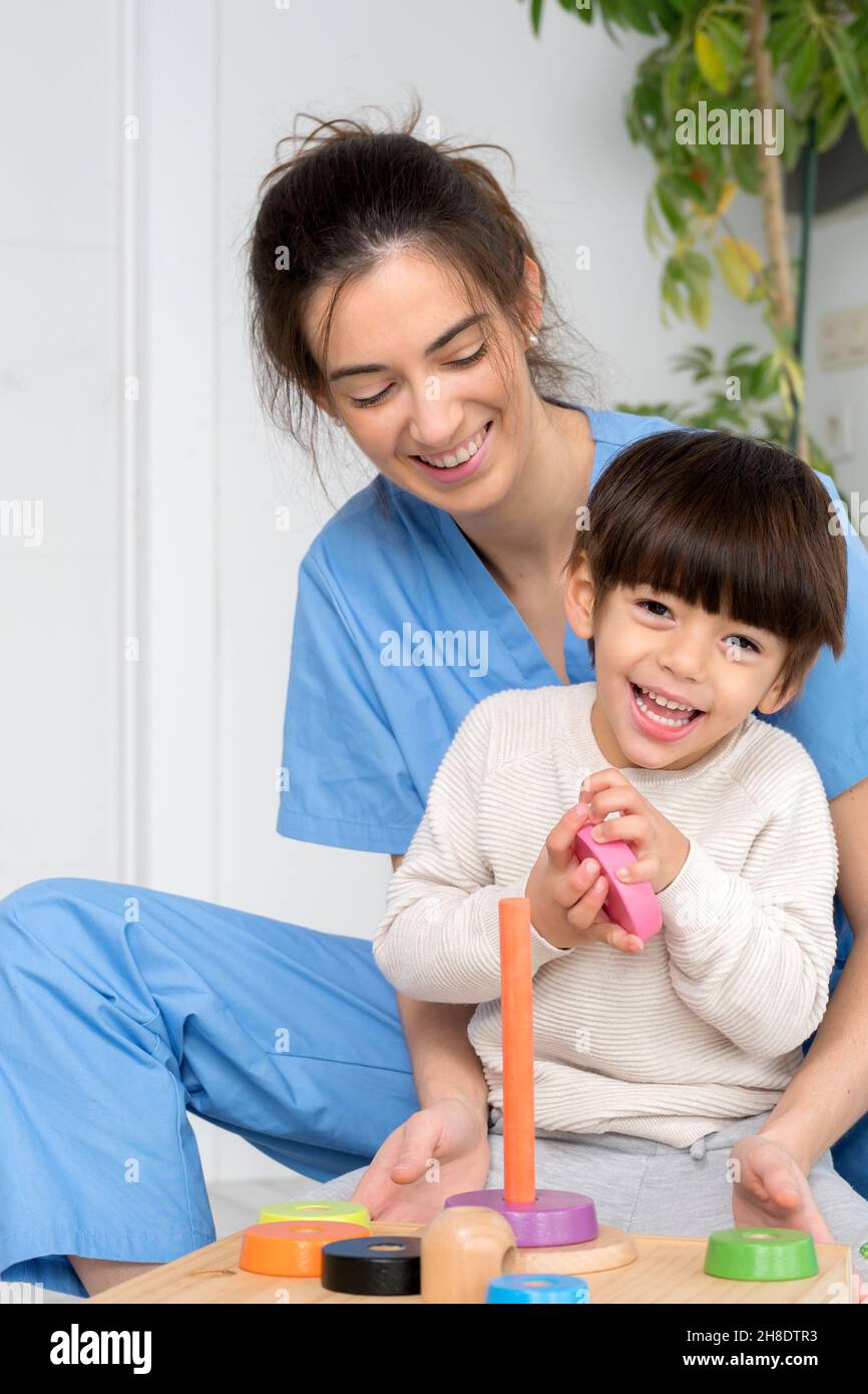 Disabled child is playing, learning and exercising in rehabilitation ...