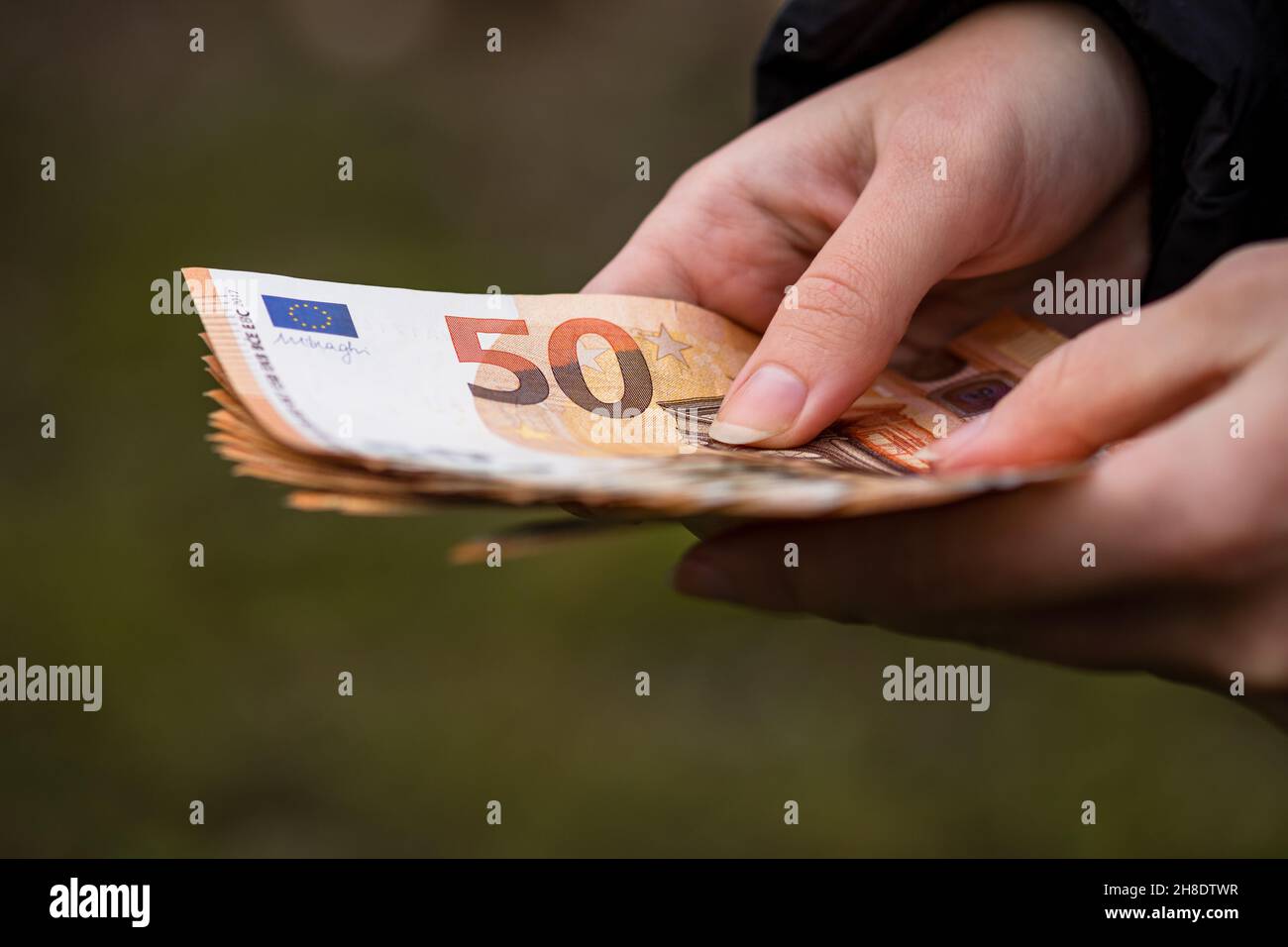 Selective focus on detail of EURO banknotes. Counting or giving EURO ...