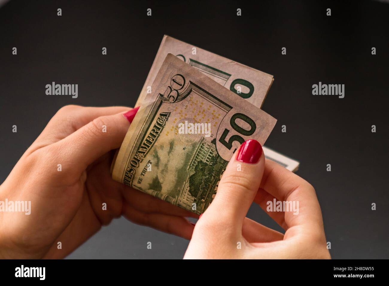 Selective focus on detail of USD banknotes. Counting or giving United ...