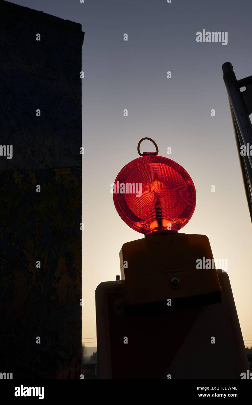 Warning light (Warnleuchte) of a construction site in the early morning ...