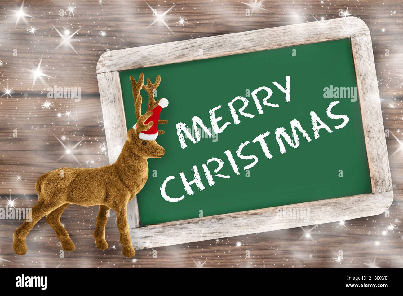 Merry Christmas and reindeer with green chalkboard Stock Photo - Alamy