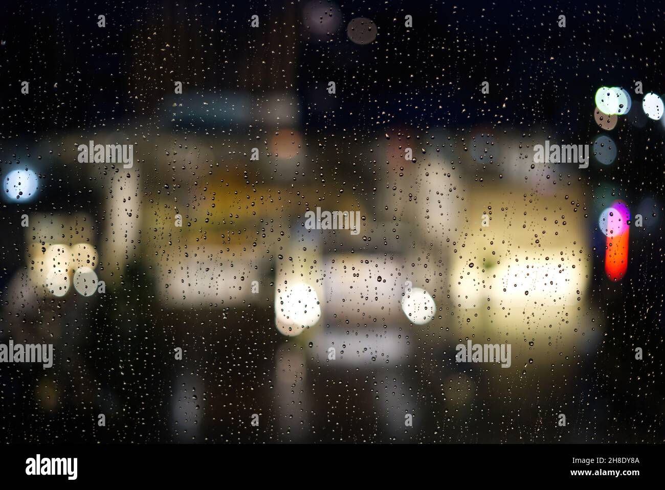Closeup shot of drops on the window with a city reflection Stock Photo ...
