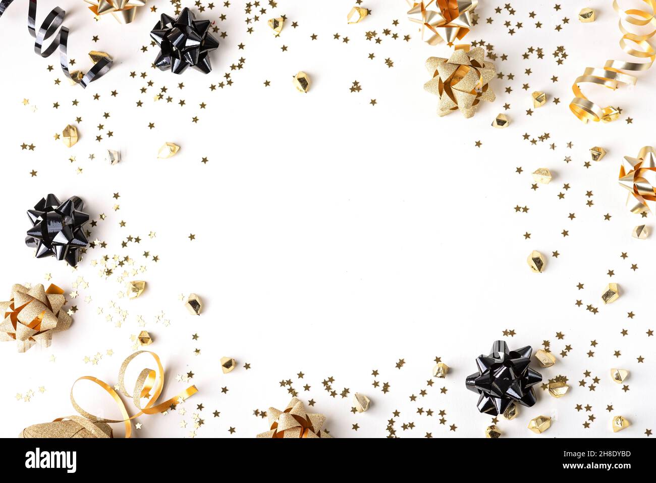 Flat lay with stylish gift present bows and gold glitter on white ...