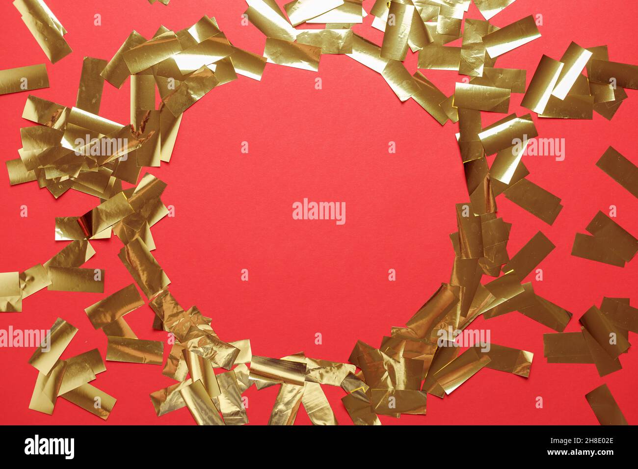 Golden color festive confetti frame on red background, top view, flat ...