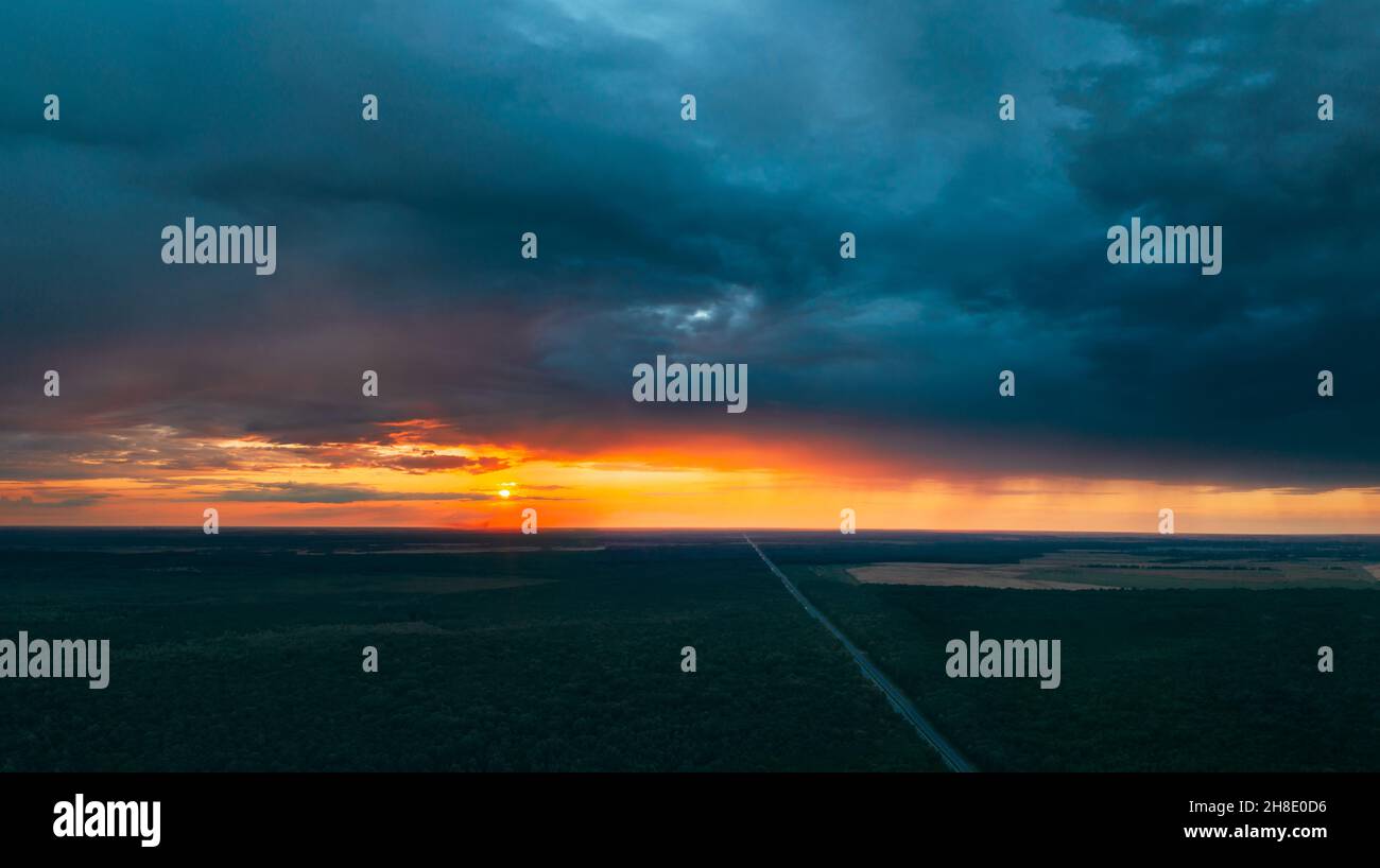 Aerial View Of Sunset Sky Above Highway Road Through Green Forest ...