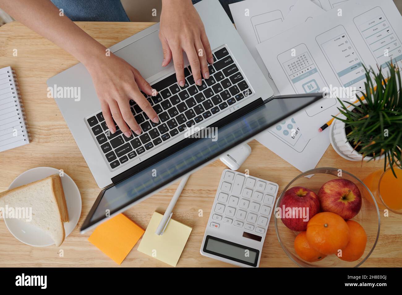 Hands of female ui designer typing on laptop and answering e-mals of ...