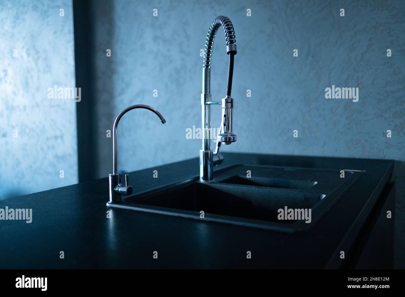 Modern kitchen faucet on black background. Home interior Stock Photo ...