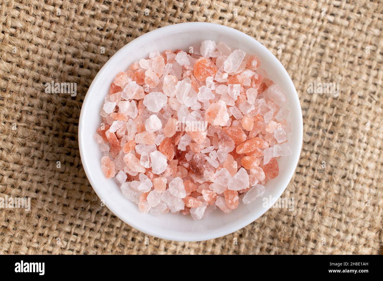 Rock salt in a salt shaker, close-up, on a jute fabric, top view Stock ...