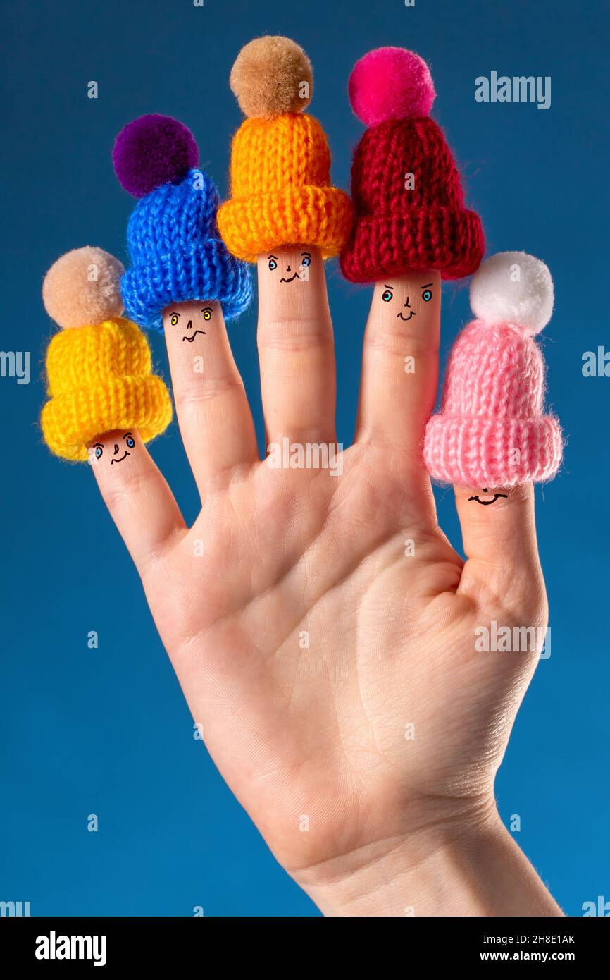 Fingers in hats with drawing of funny smiling faces Stock Photo - Alamy
