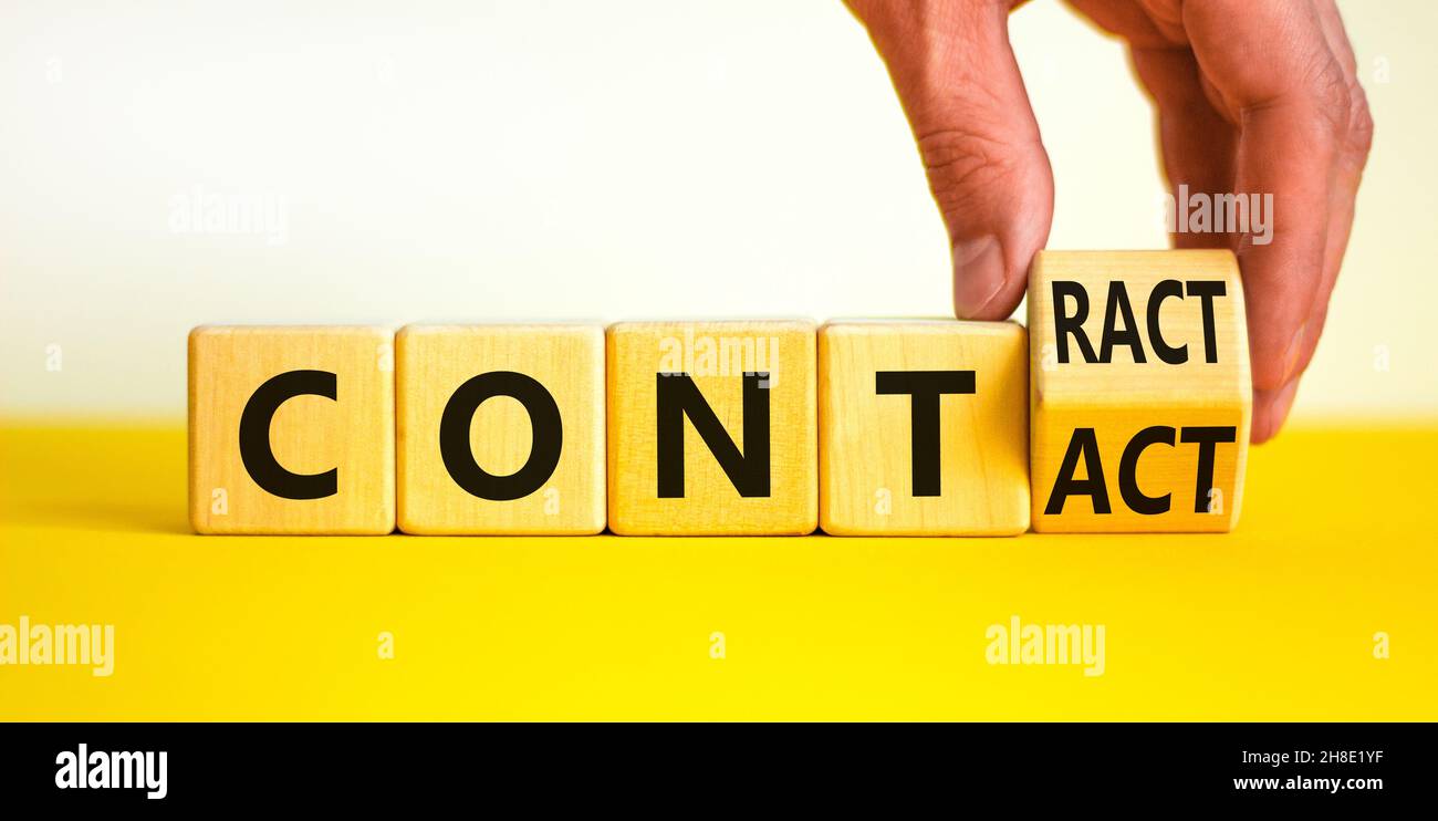 From contact to contract symbol. Businessman turns a wooden cube and ...