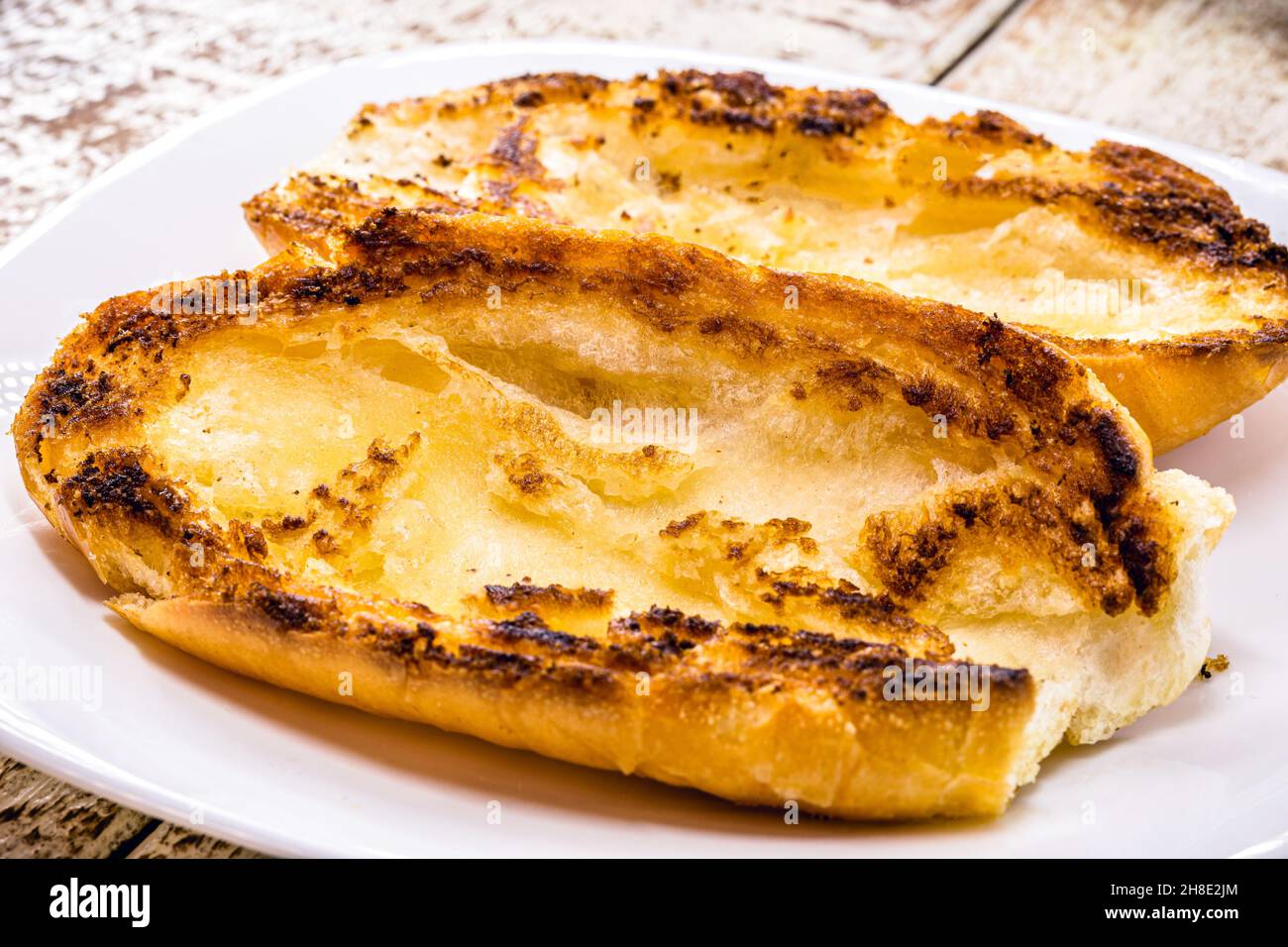 Brazilian breakfast snack called bread in the "chapa". French bread cut ...