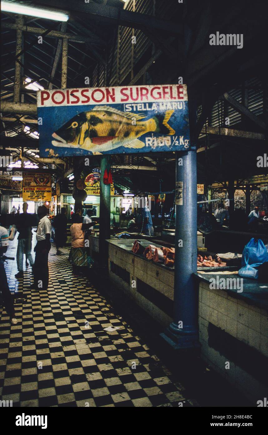 An aisle inside the historic market hall of Port Louis with a large ...