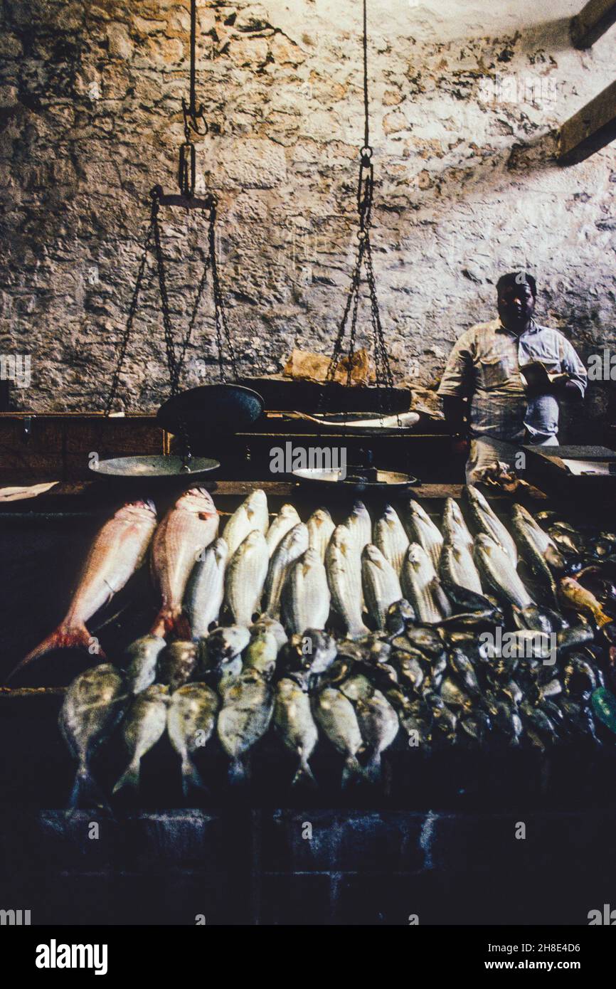 A fishmonger at the historic market hall of Port Louis Stock Photo - Alamy