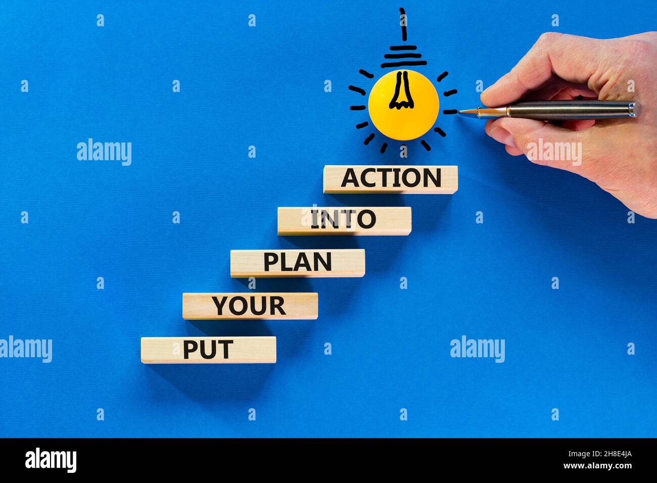Put your plan into action symbol. Wooden blocks with words Put your ...