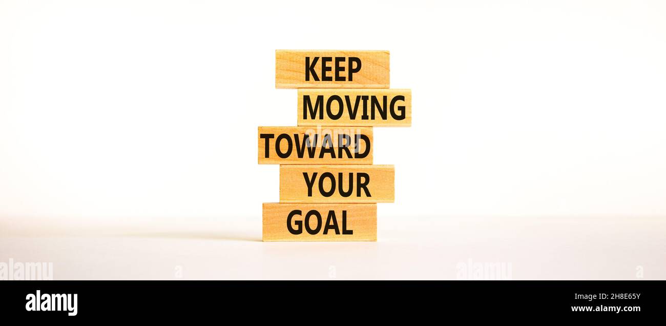 Keep moving toward your goal symbol. Wooden blocks with words Keep ...