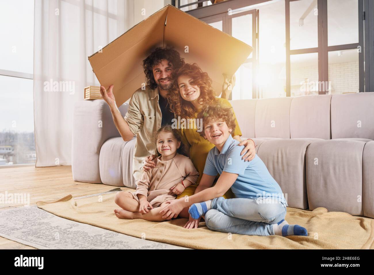 Happy family play together under a cardboard roof Stock Photo - Alamy