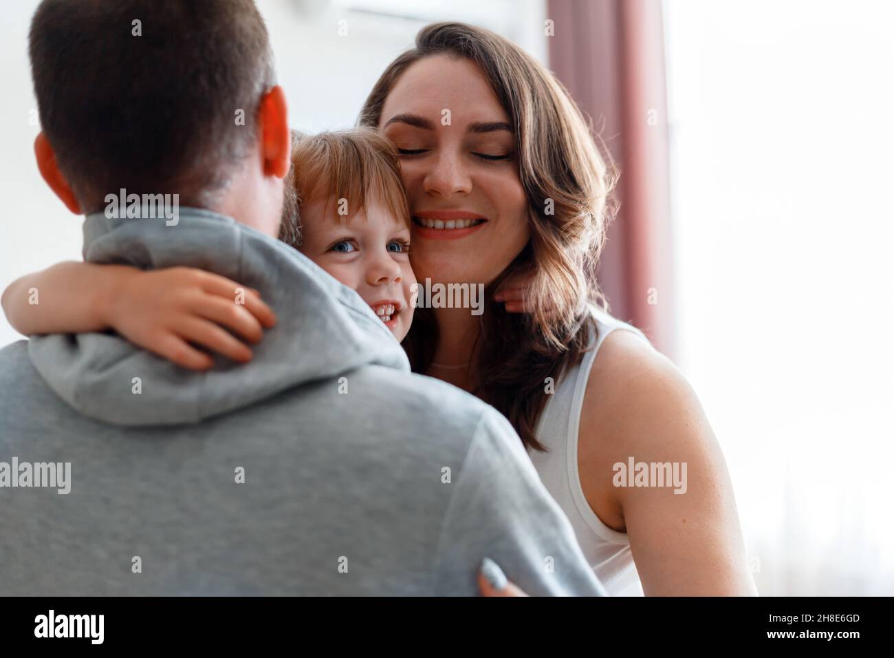 Happy family hugging. Little smiling child kid girl daughter hugs mom ...
