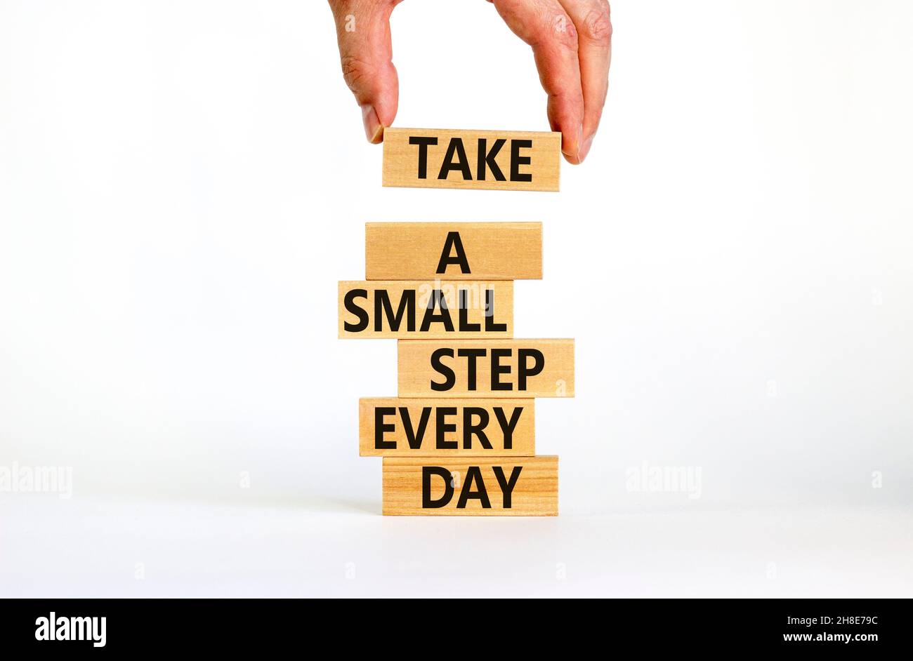 Take a small step every day symbol. Wooden blocks with words Take a ...