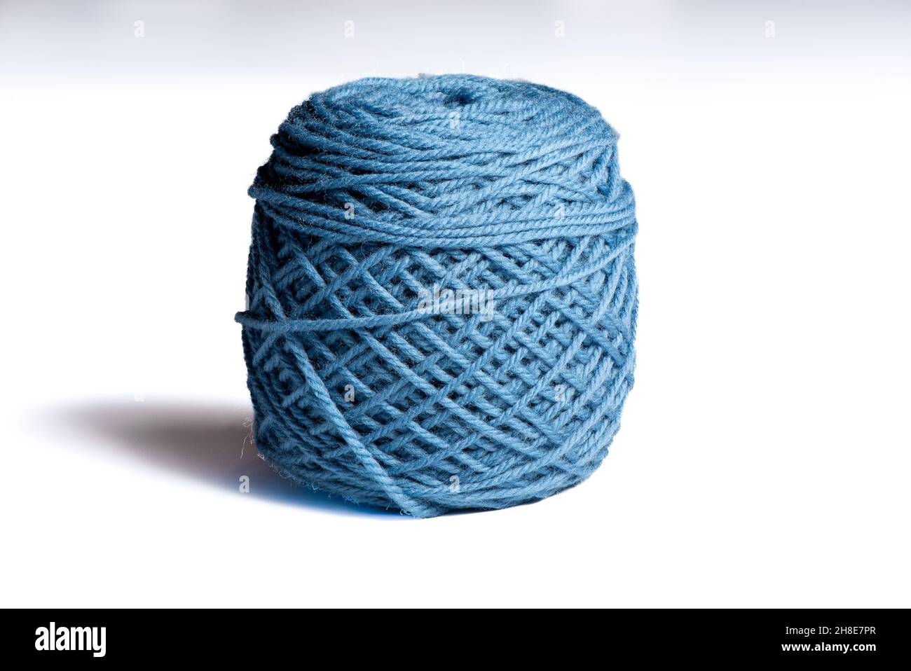 Ball of light blue yarn on a white background Stock Photo - Alamy