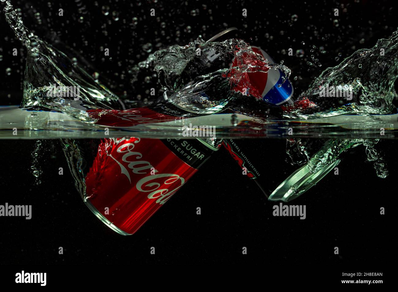 Close up view of can of coca cola, pepsi cola falling into water ...