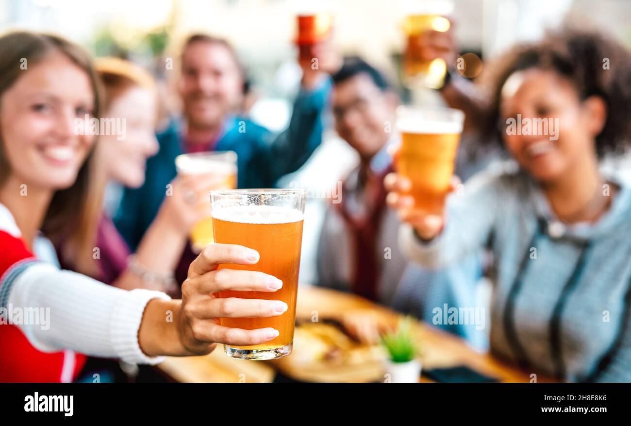 Blurred background of friends drinking and toasting beer at brewery bar ...