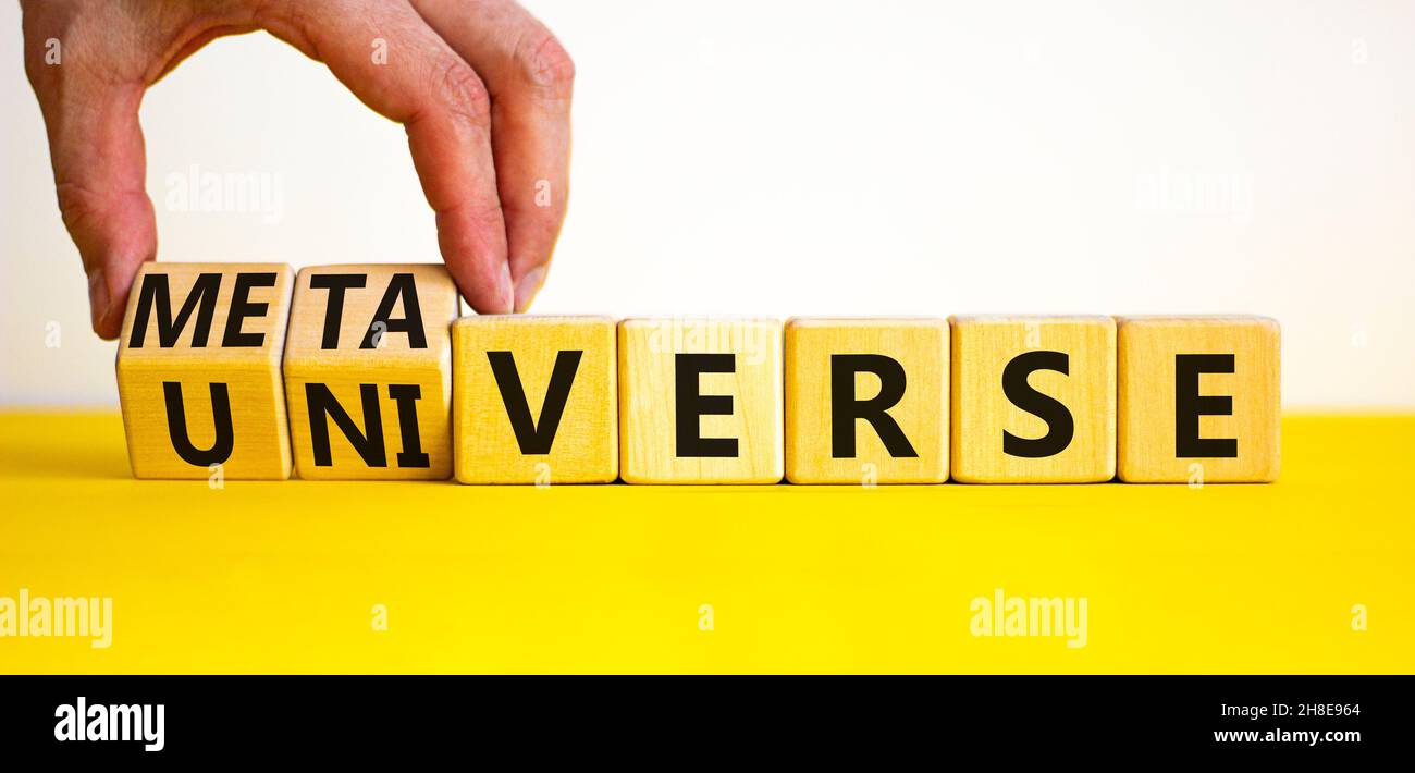 Universe or metaverse symbol. Businessman turns wooden cubes and ...