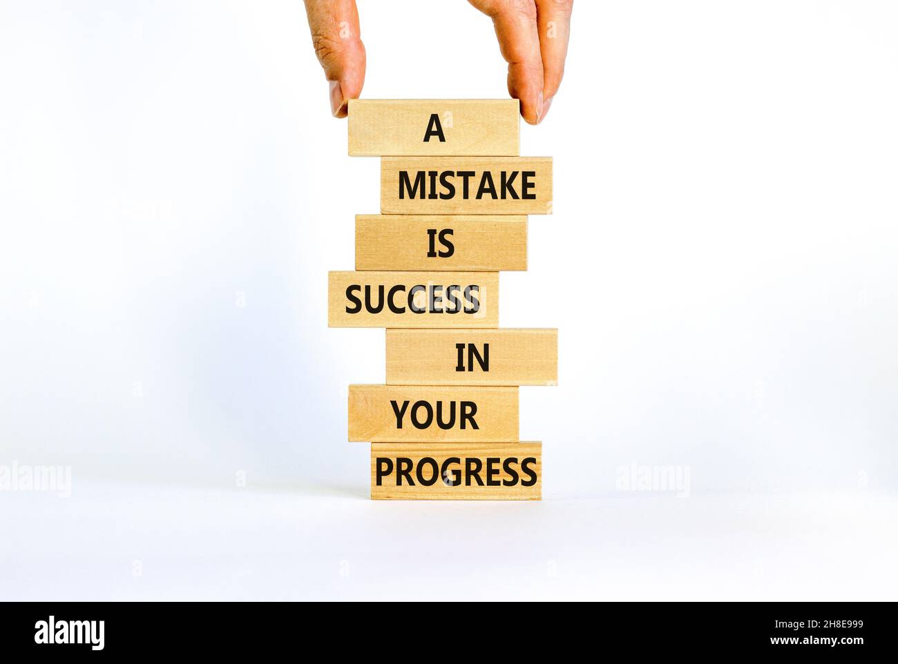 Mistake or success symbol. Wooden blocks with words A mistake is ...