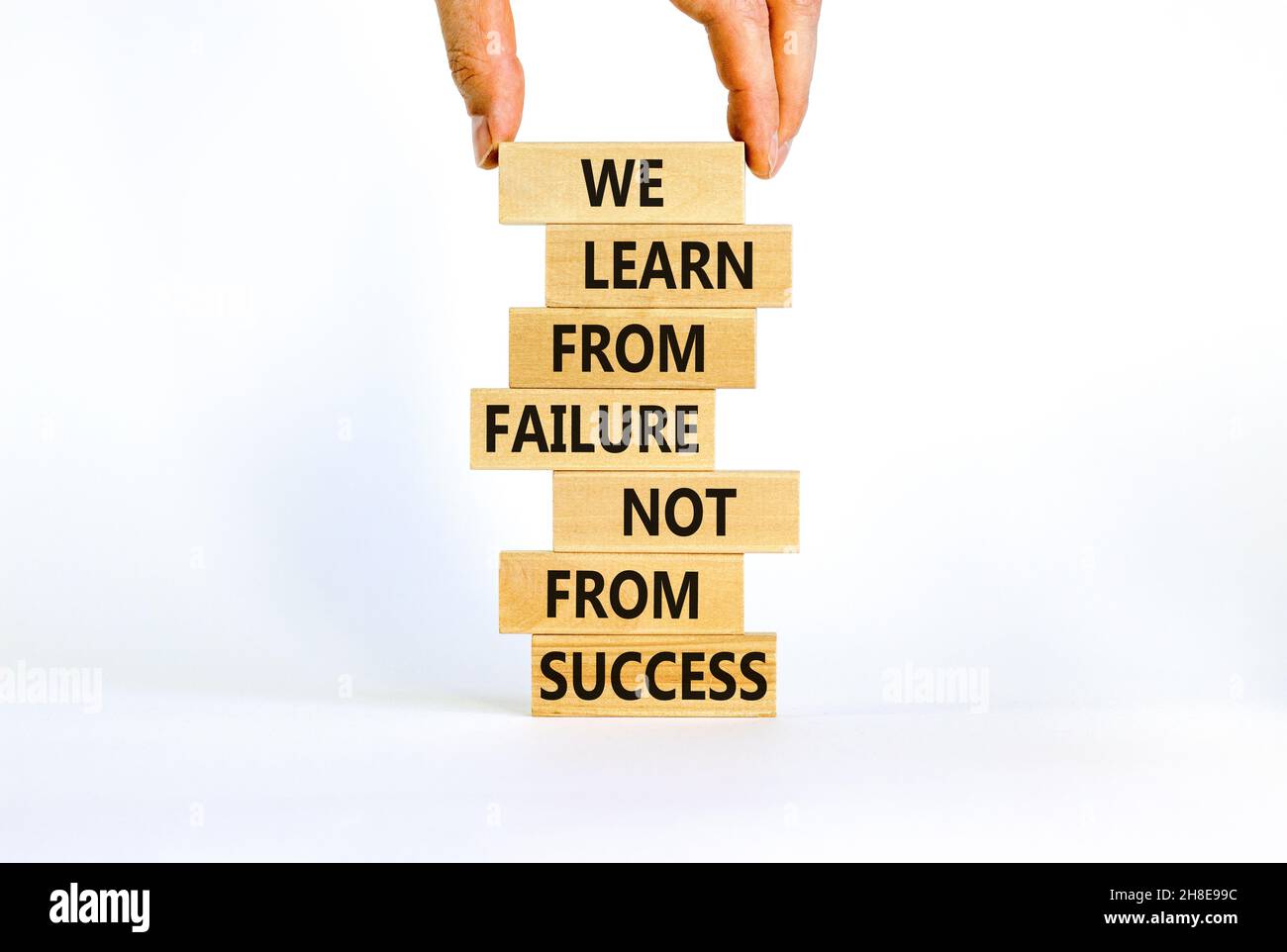 Failure or success symbol. Wooden blocks with words We learn from ... Failure or success symbol. Wooden blocks with words We learn from ...