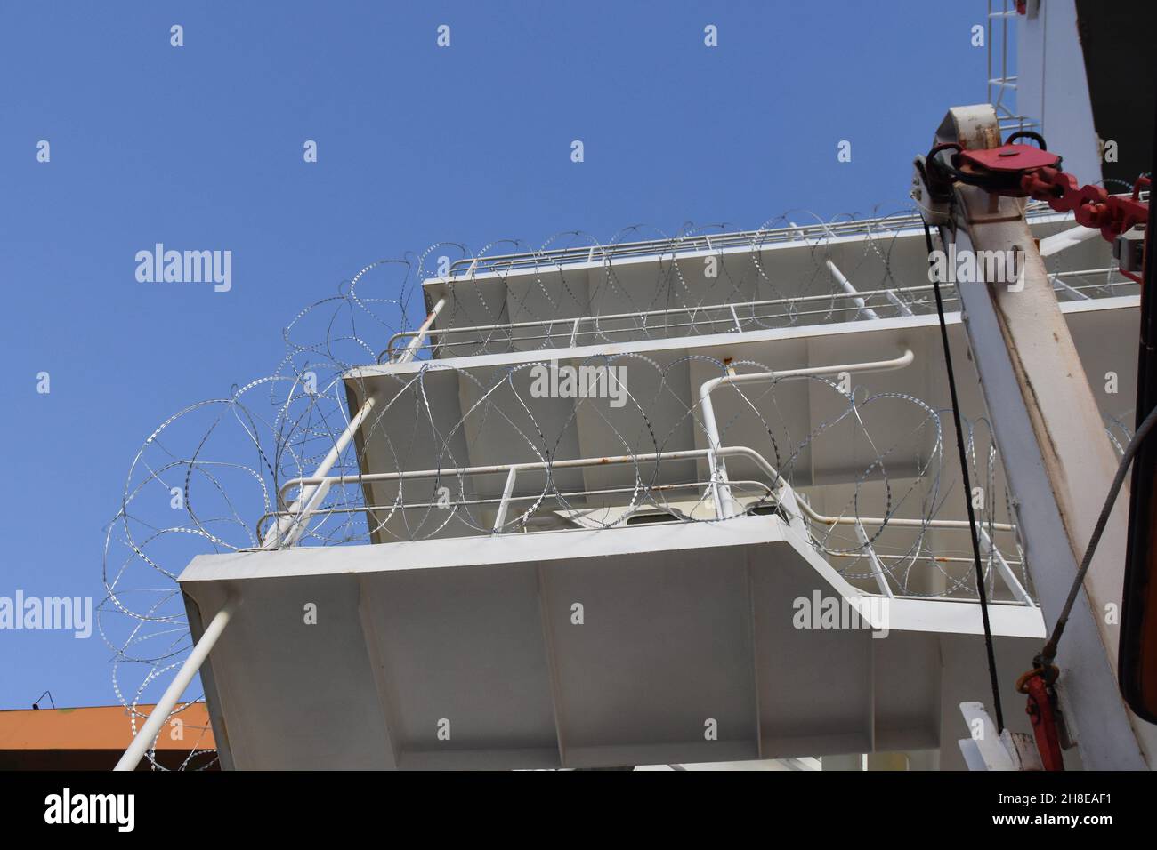 Barbed wire or razor wire attached to the ship superstructure, hull and ...