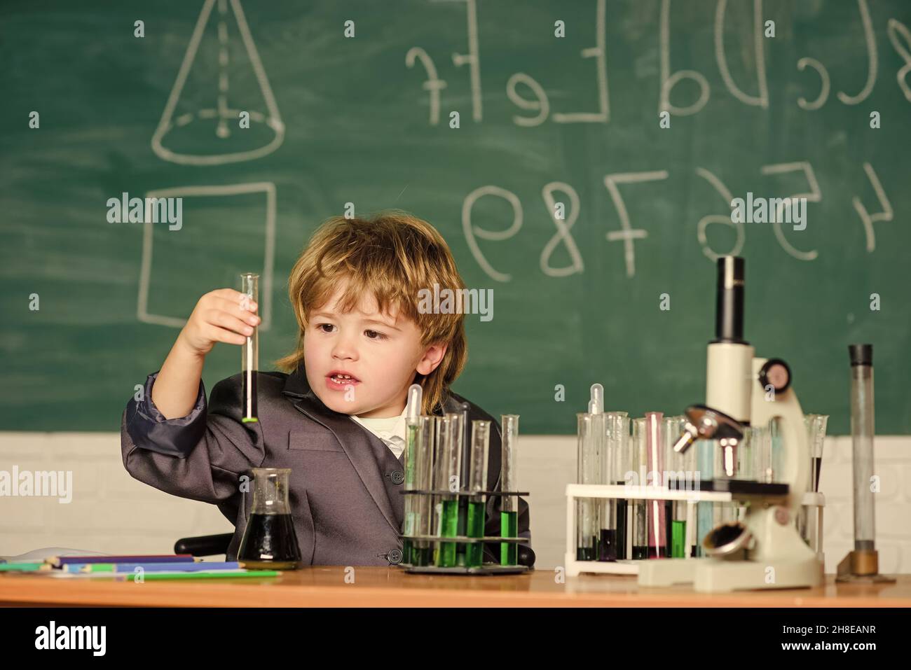 science experiments with microscope in lab. biology. school kid ...