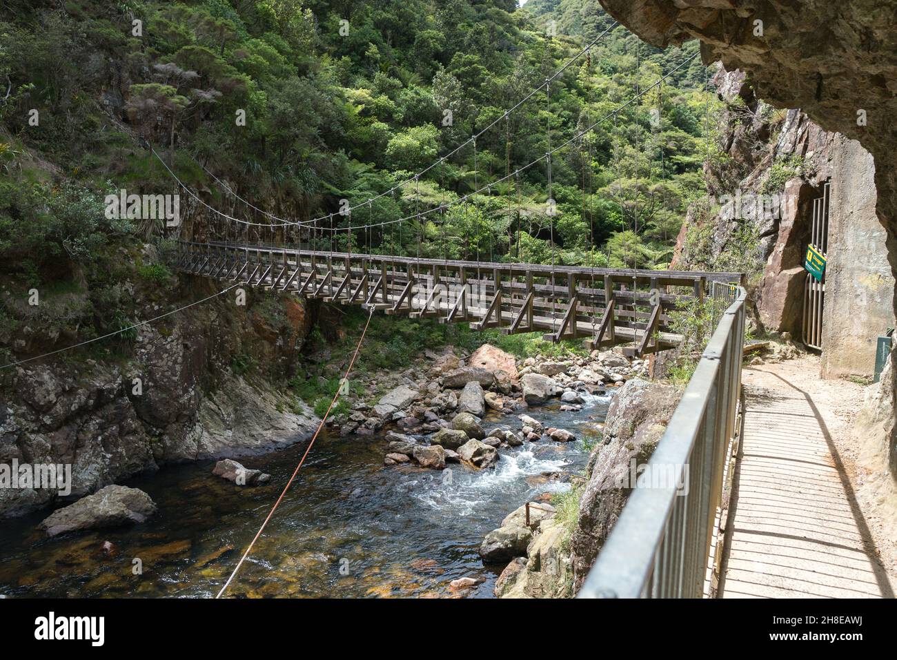 The walking path on the hanging bridge crossing the river at the gorge ...